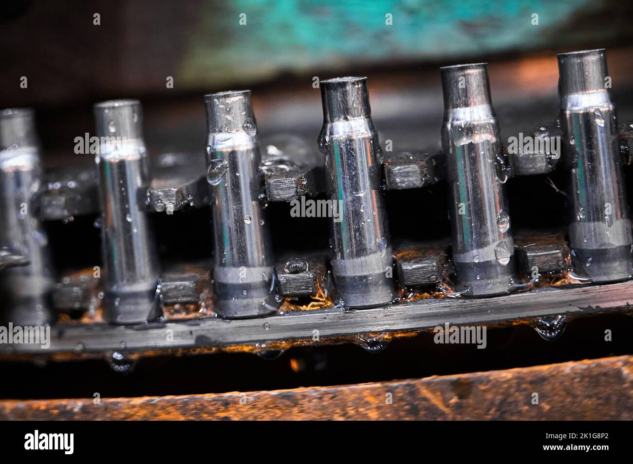 Shell casings transported by vintage equipment at plant Stock Photo - Alamy