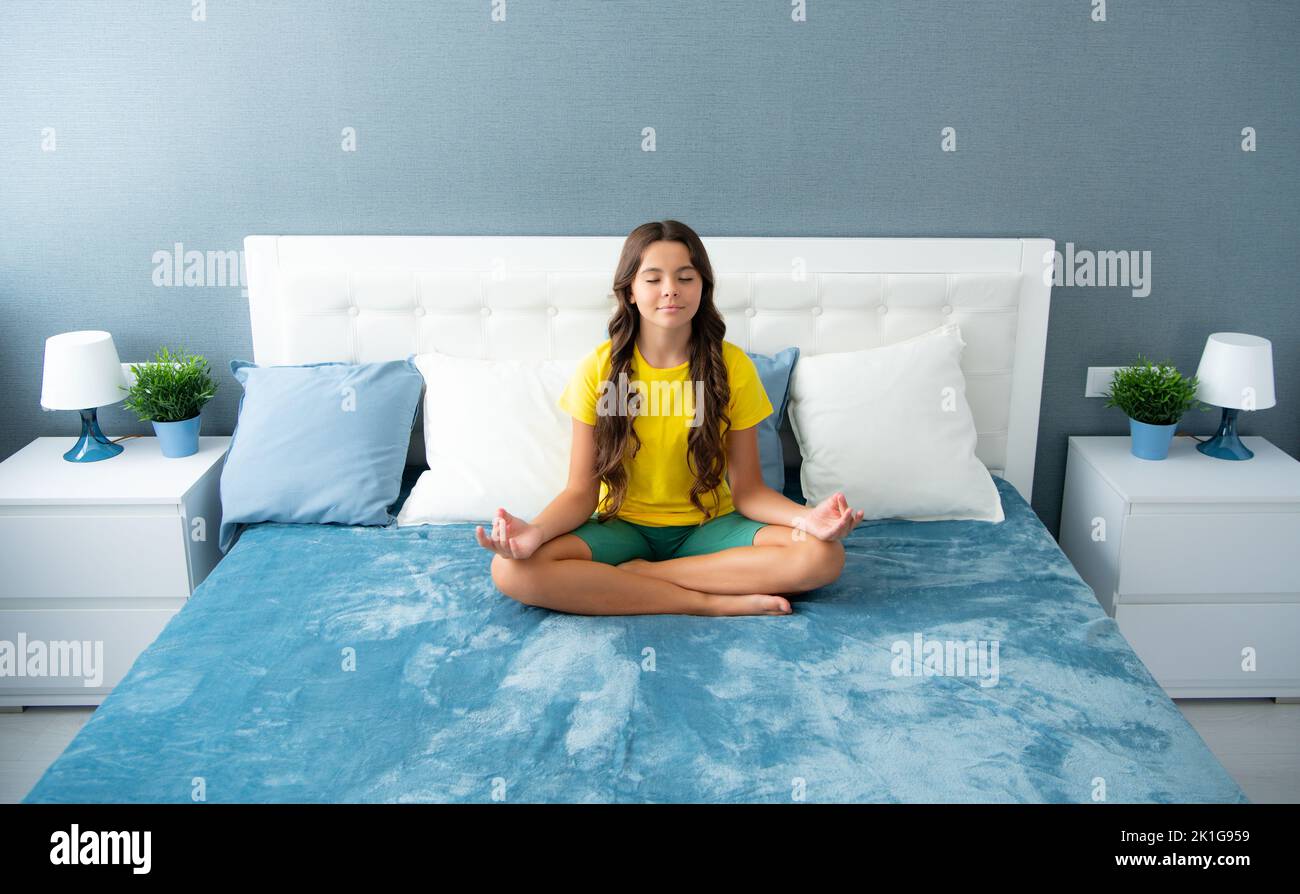 Morning Meditation on bed. Teenager child practicing meditation at ...