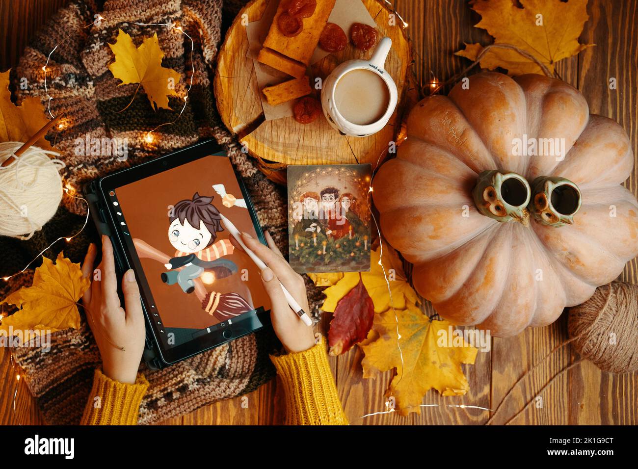 Scarf, coffee, pie, pumpkin, leaves and garland on a wooden table Stock ...