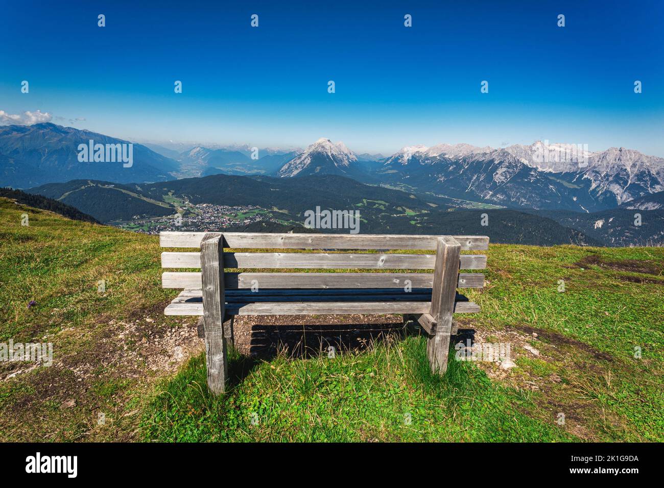 A wooden bench overlooking scenic mountains Stock Photo - Alamy