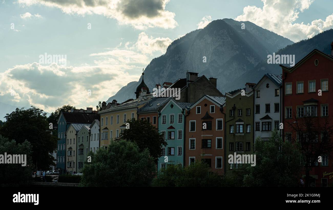 A beautiful shot of colorful buildings with a mountain top in the ...