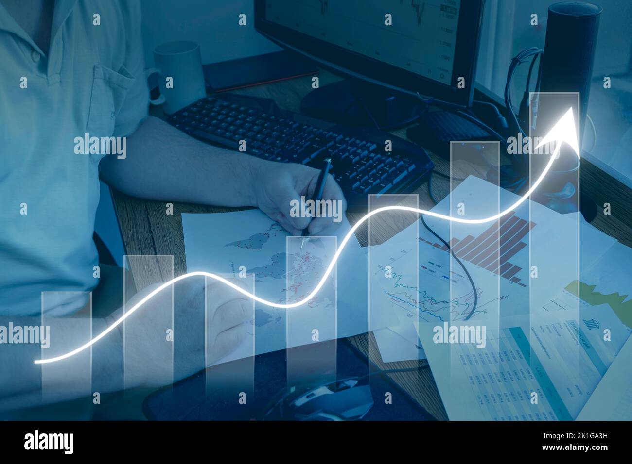 A Caucasian man studying papers with maps, charts and graphs. Concept ...