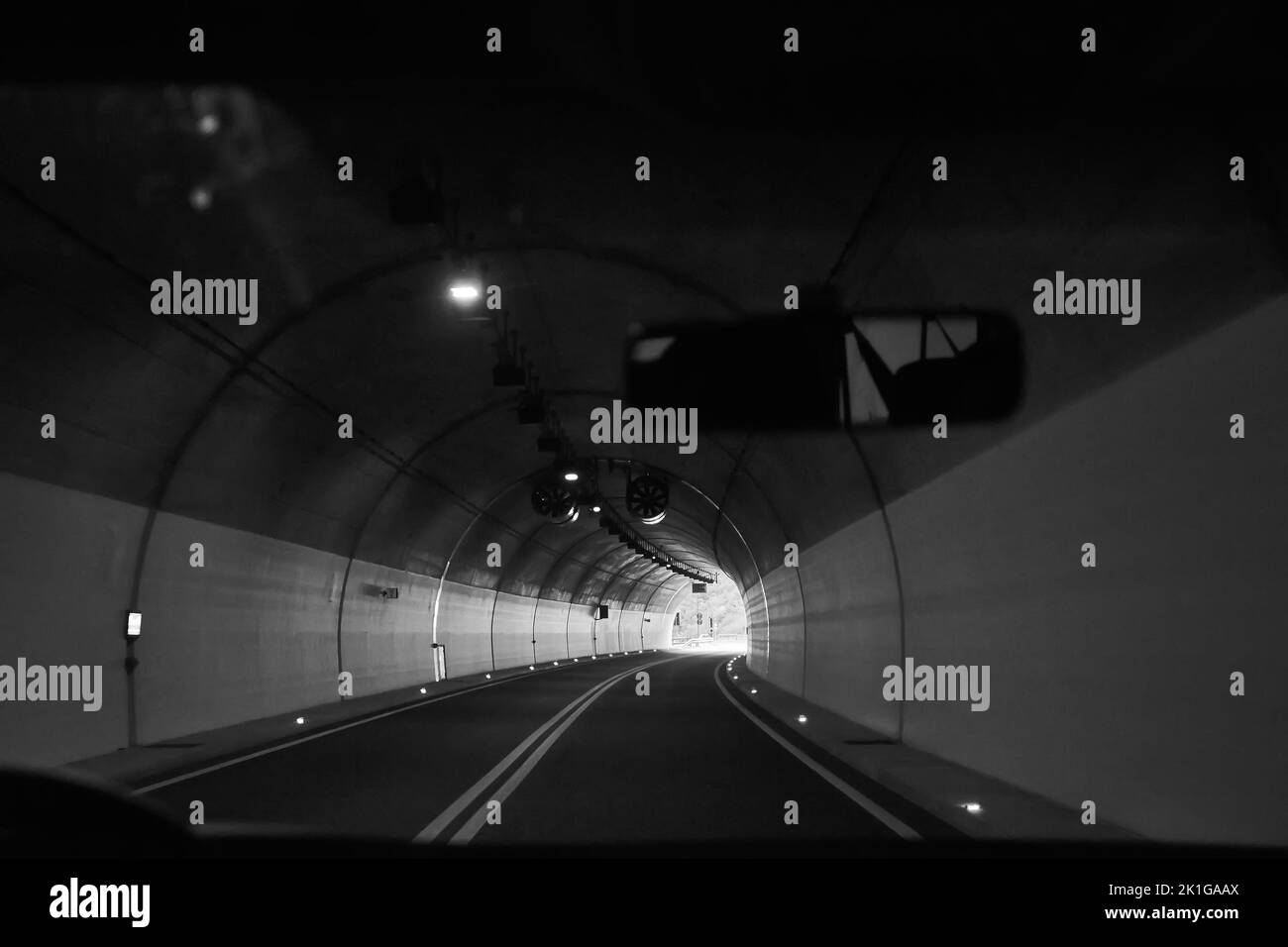 View inside of car moving in empty road tunnel. Man driving automobile ...