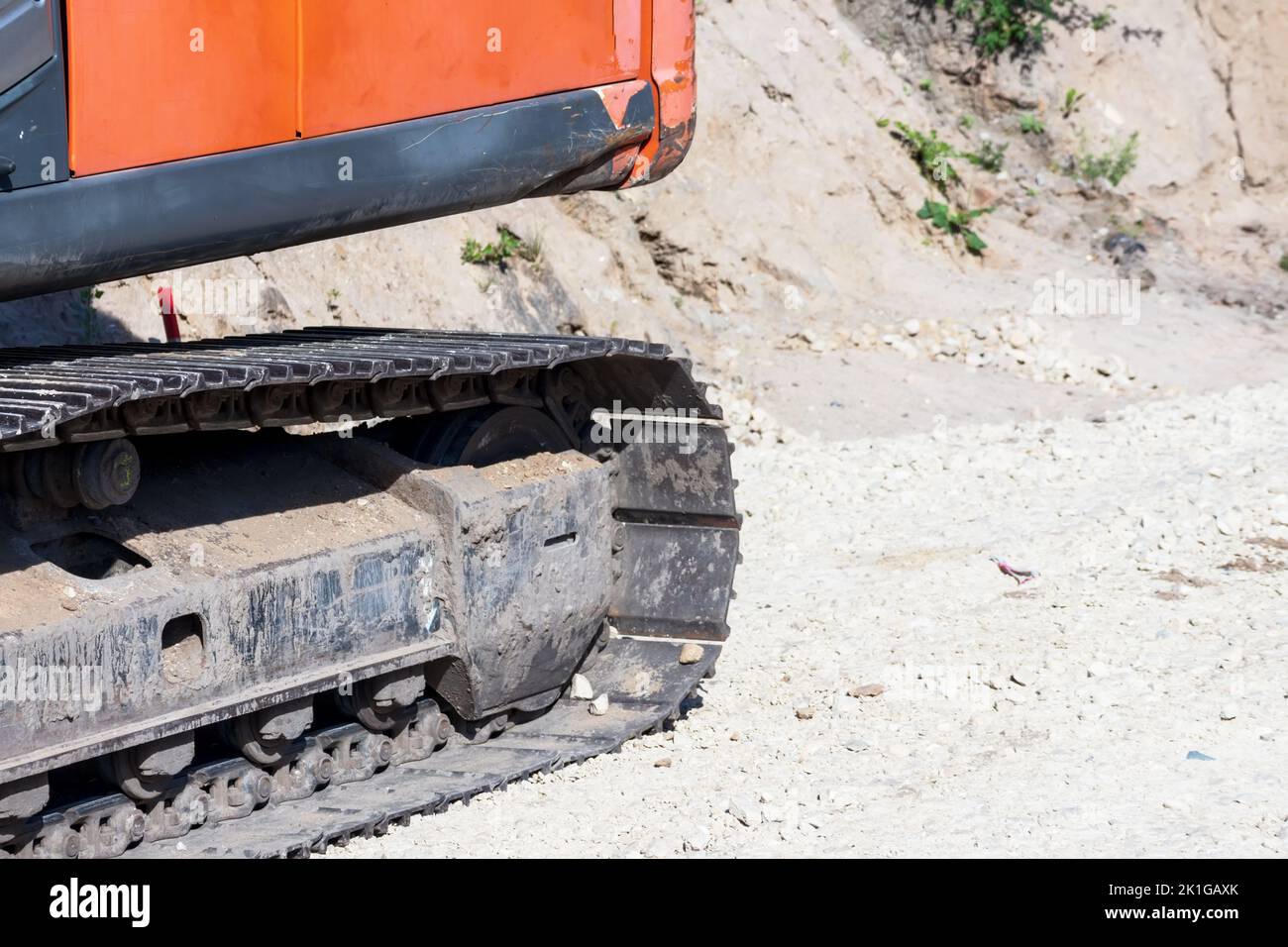 Orange road crane on gravel construction site with tracks Stock Photo ...
