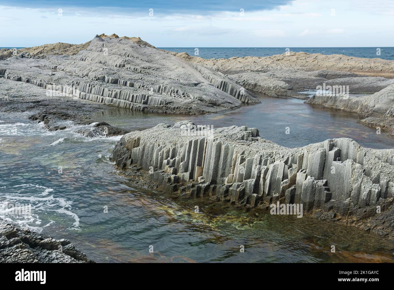 coastal cliffs formed by columnar basalt at low tide Stock Photo - Alamy