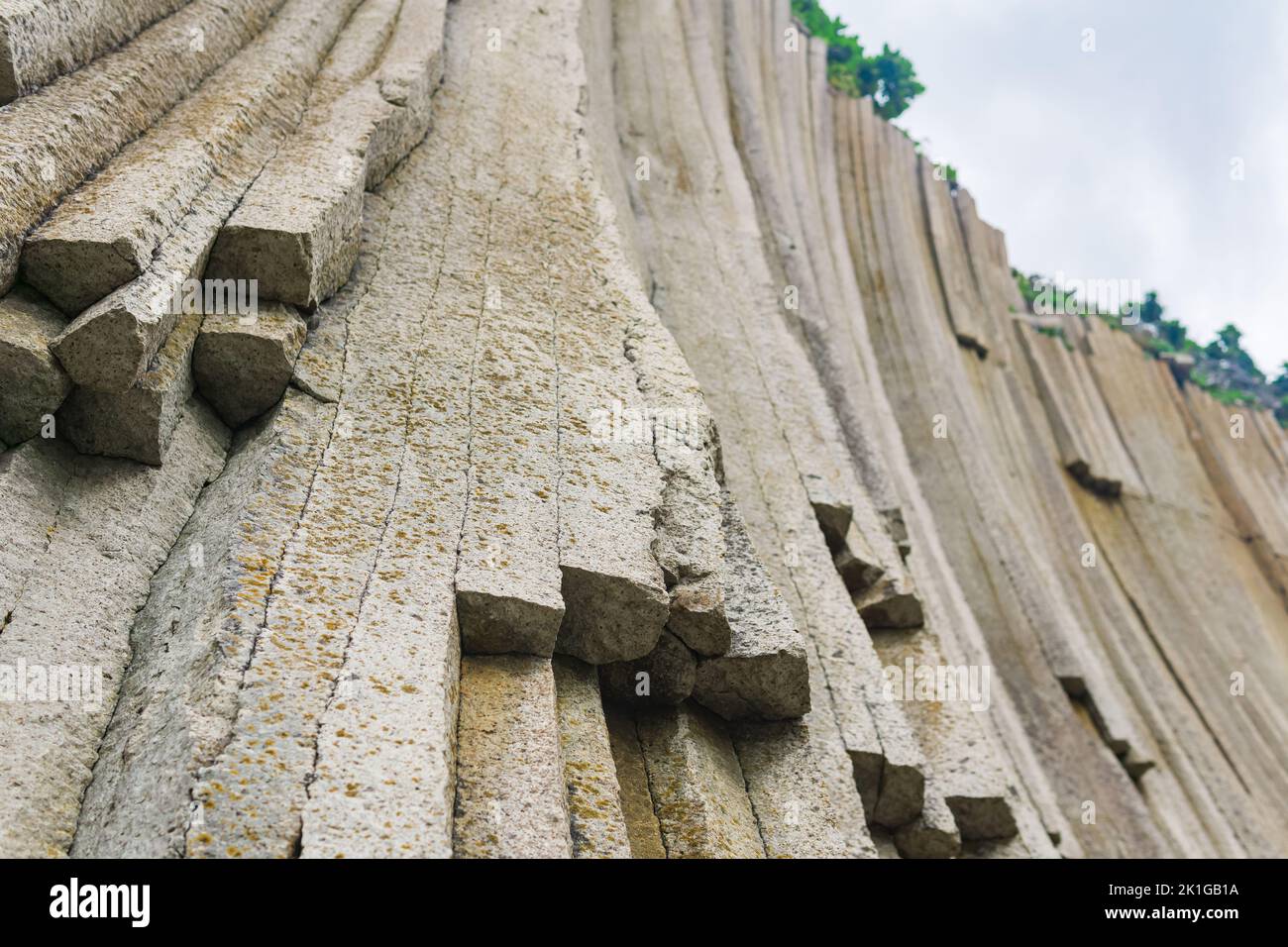basalt columns forming a coastal rock at Cape Stolbchaty on Kunashir ...
