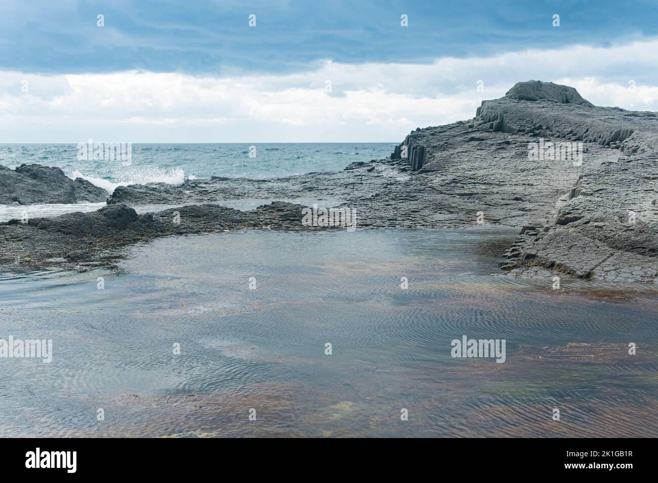 coastal cliffs formed by columnar basalt at low tide Stock Photo - Alamy