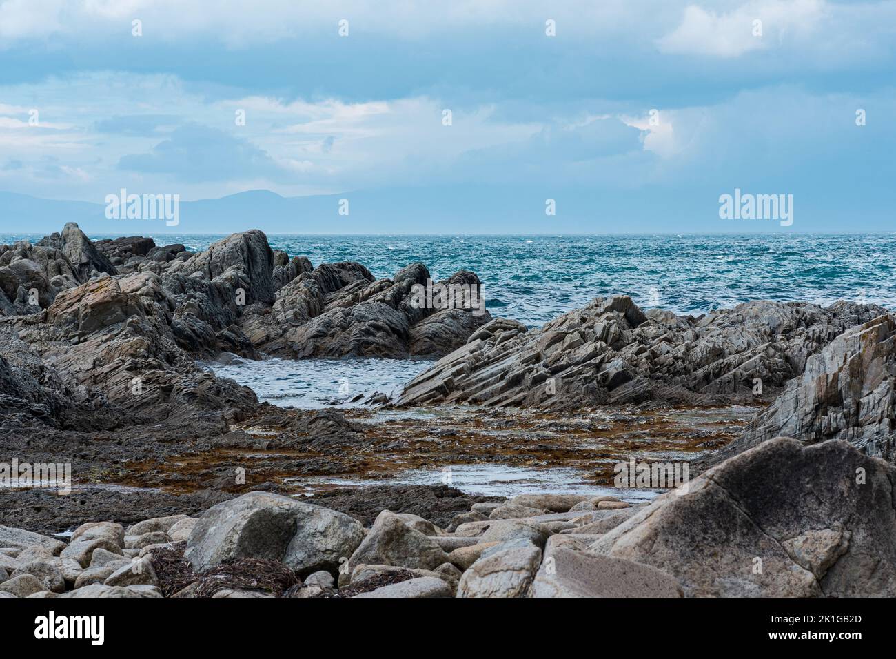 sharp jagged basalt rocks on the sea coast Stock Photo - Alamy