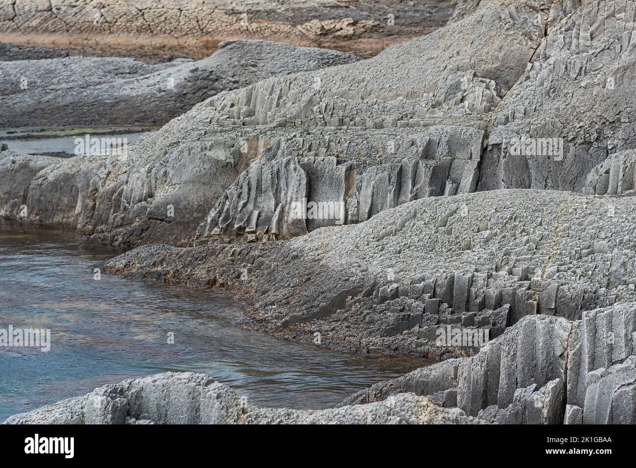 coastal cliffs formed by columnar basalt at low tide Stock Photo - Alamy