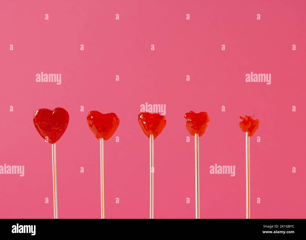Heart shaped lollipops on pink background Stock Photo - Alamy