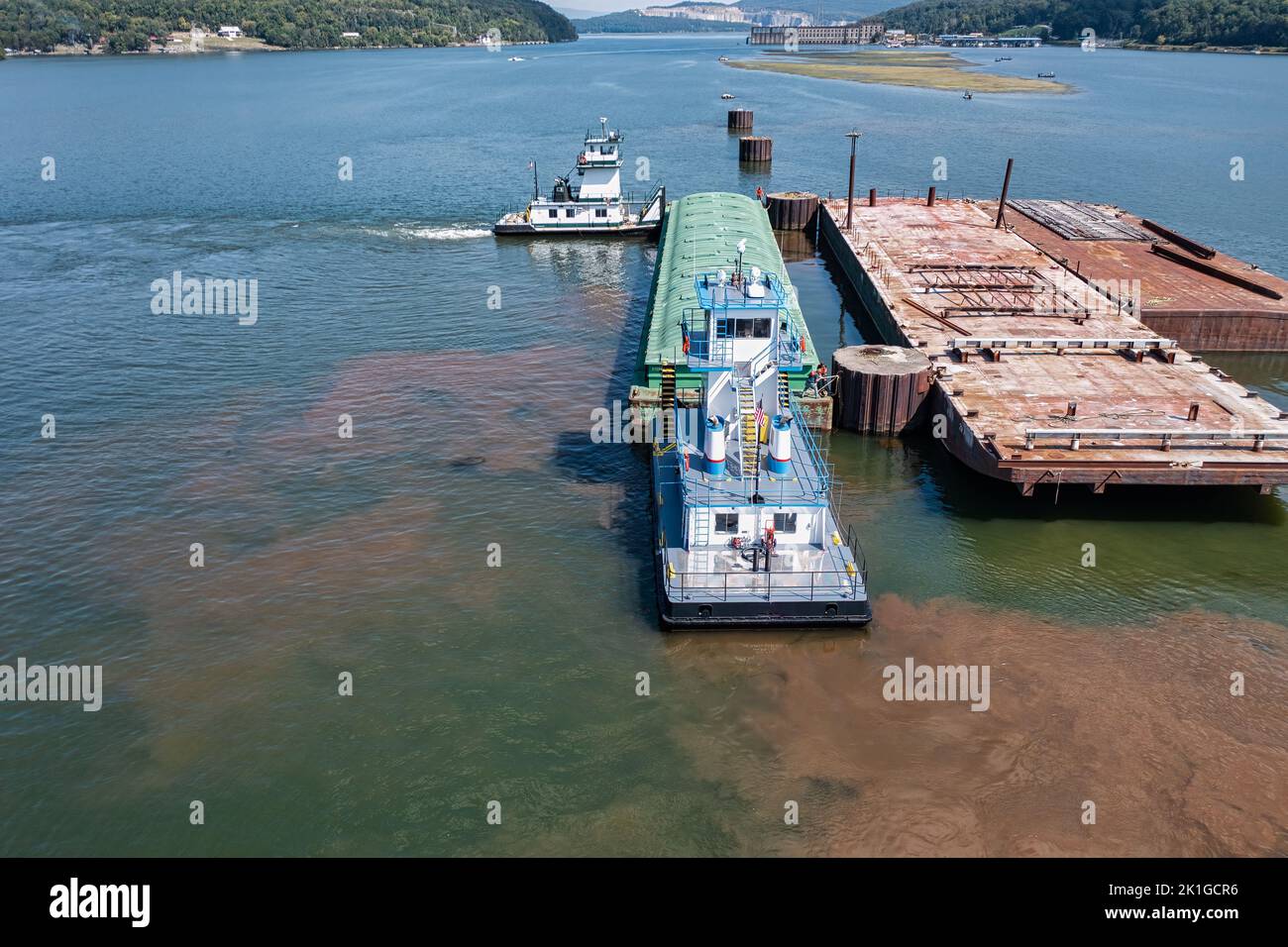 Towboat and a push boat docking a barge on the Tennessee River near ...