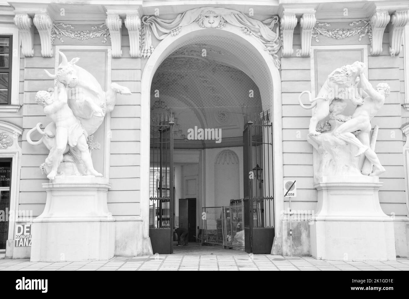 A closeup grayscale of a building and gate of the Spanish Riding School ...
