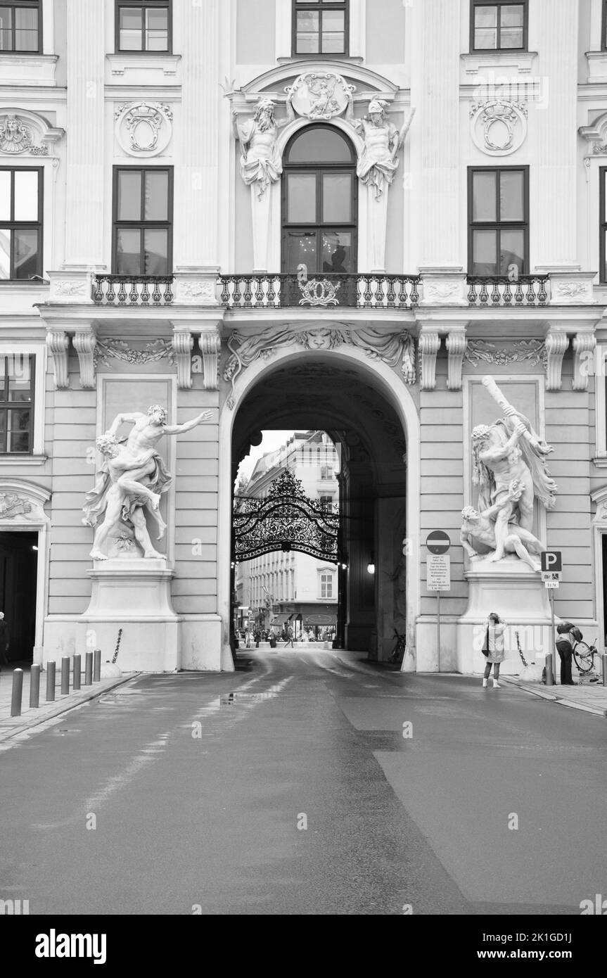 A vertical closeup grayscale of a building and gate of the Spanish ...