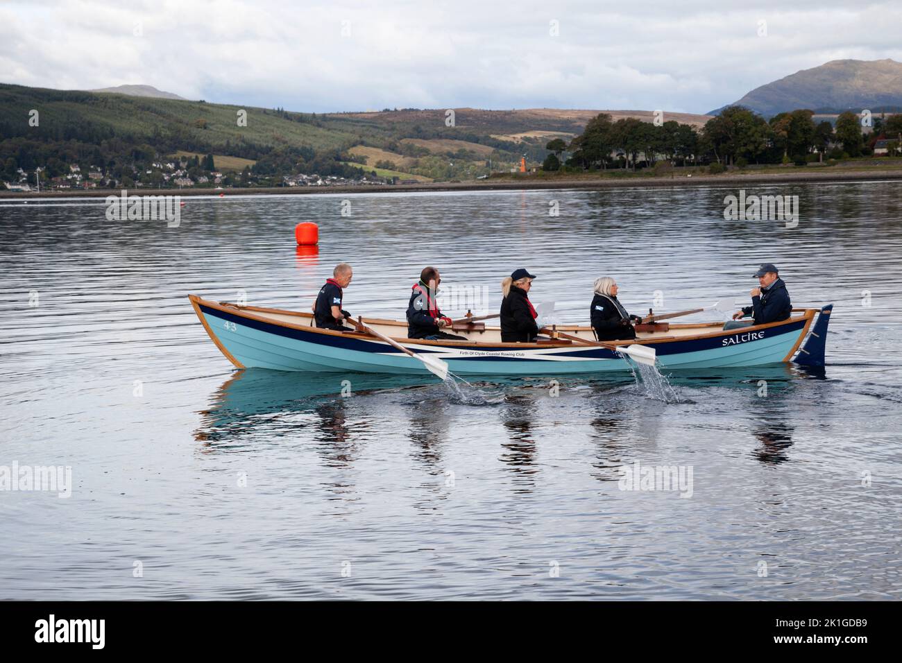Firth of Clyde Rowing Club from Largs with their boat Saltire. Coastal ...