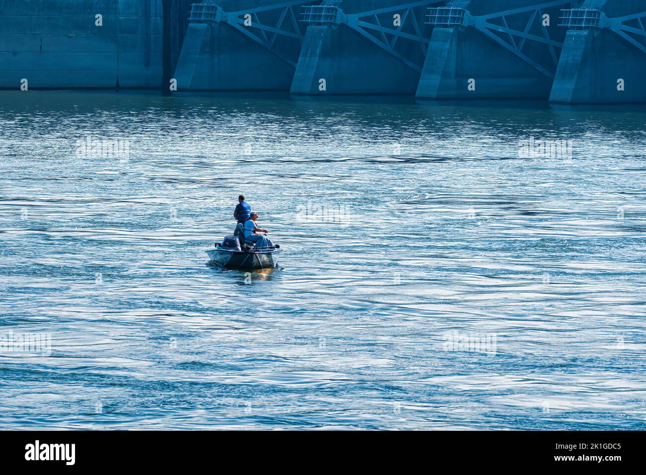 Fishermen fishing from boat below dam on Tennessee River Stock Photo ...