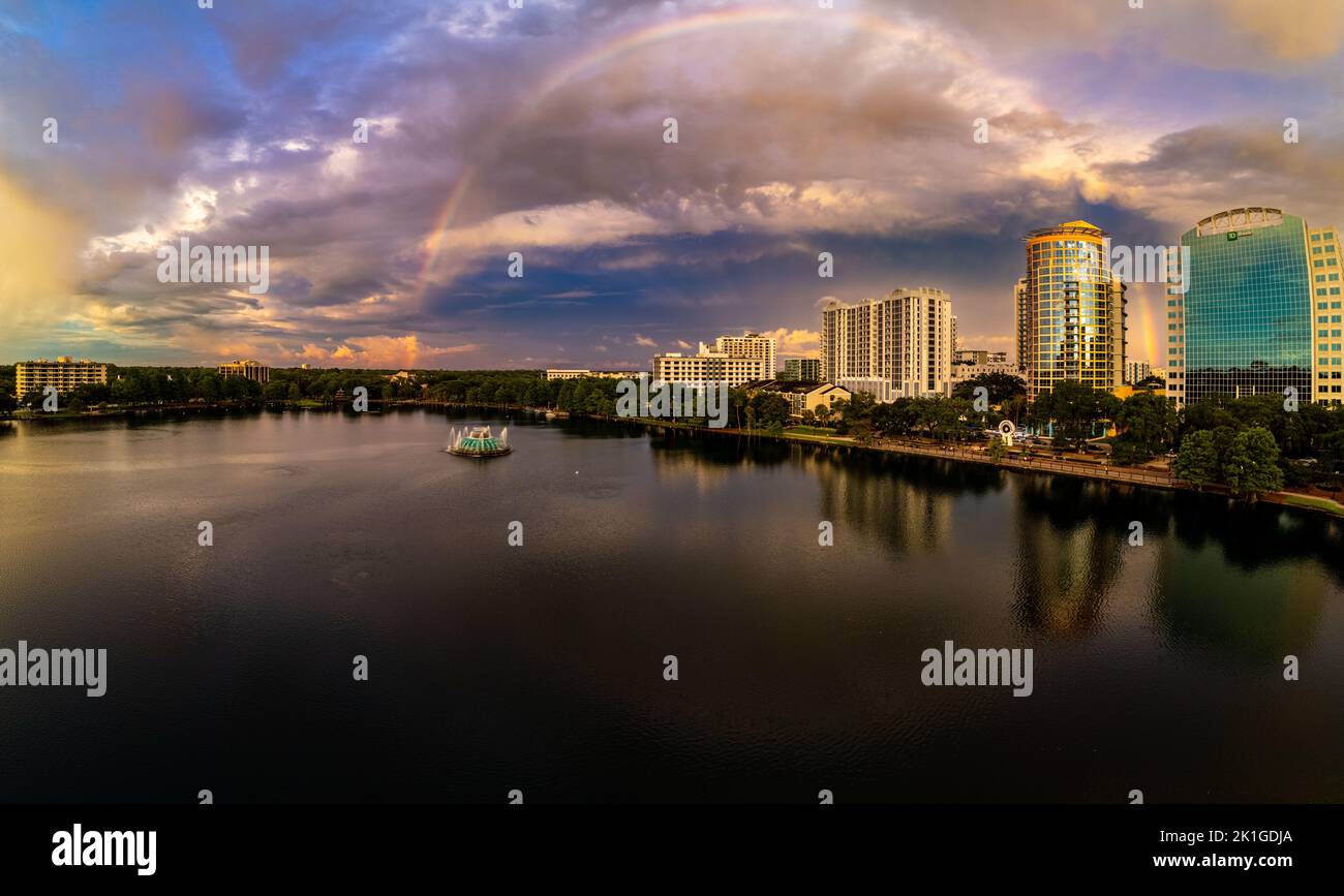 An aerial view of a rainbow and cloudy sky over Lake Eola in Orlando ...