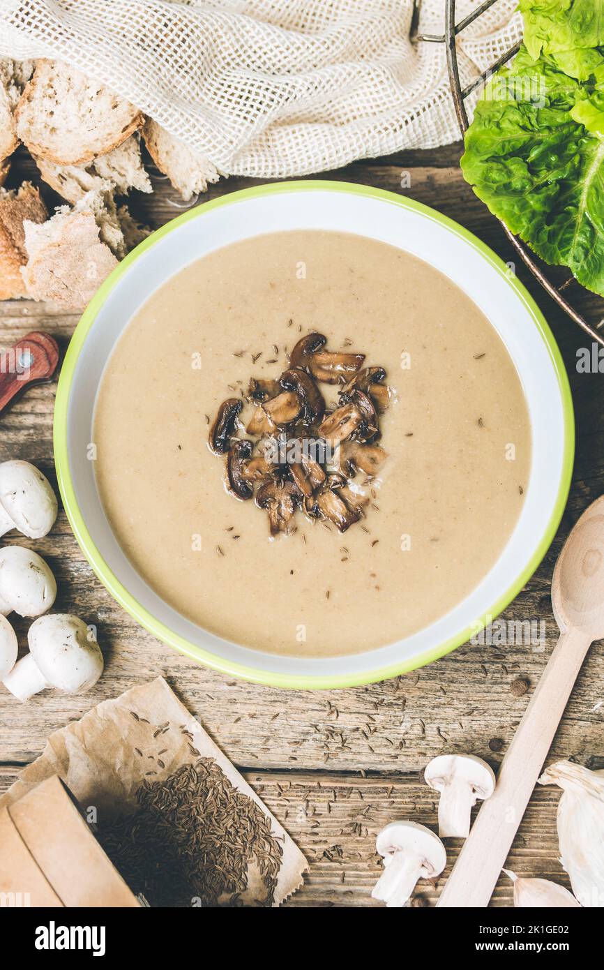 Vegan mixed soup from button mushrooms. Served on wooden table ...