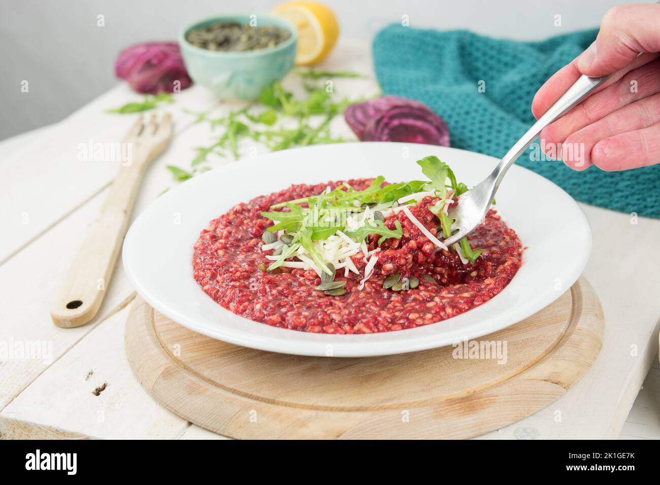Vegan food, cream beetroot risotto decorated with vegan cheese, pumpkin ...