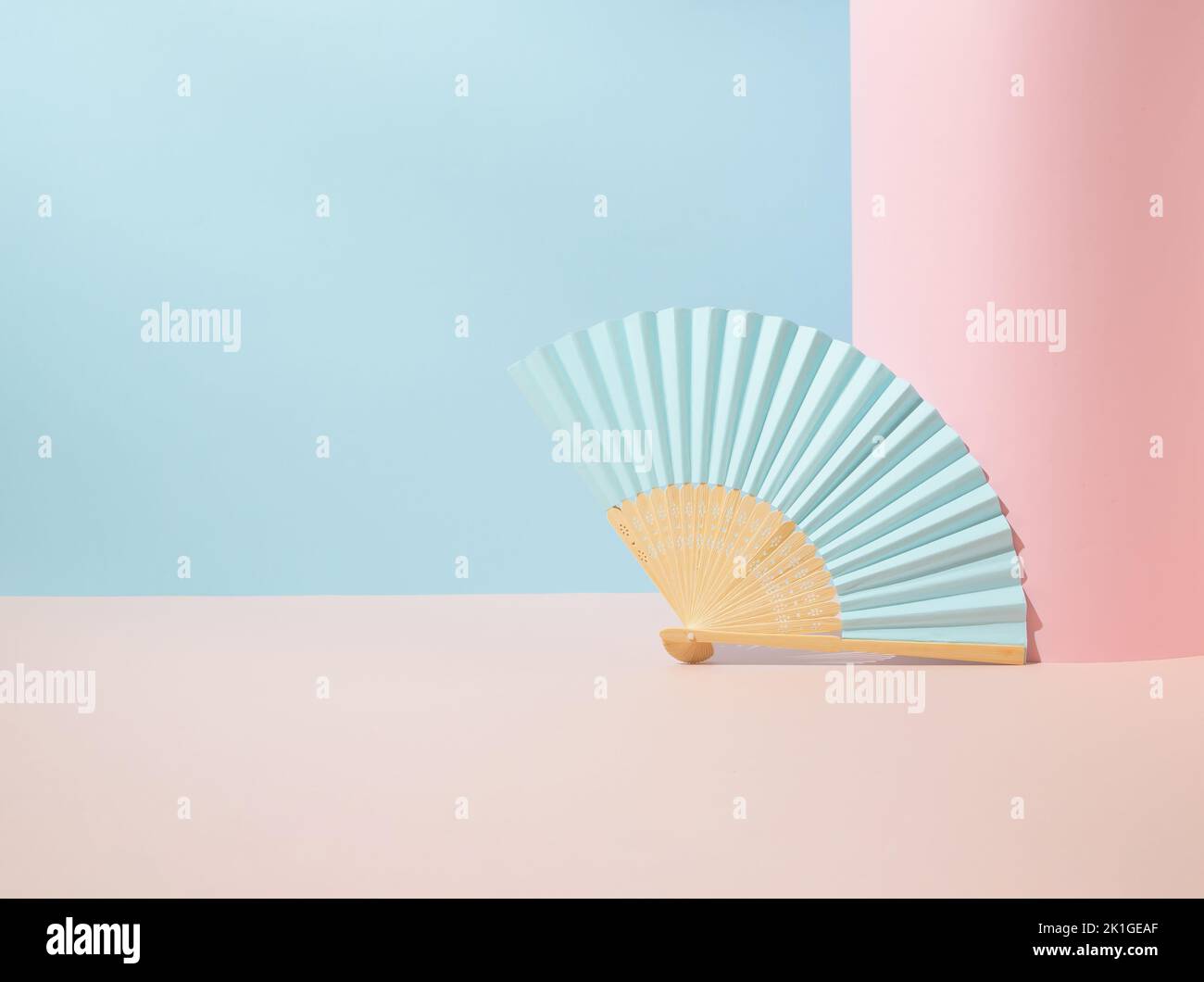 Blue paper fan on geometrical blue and pink background. Minimal concept ...