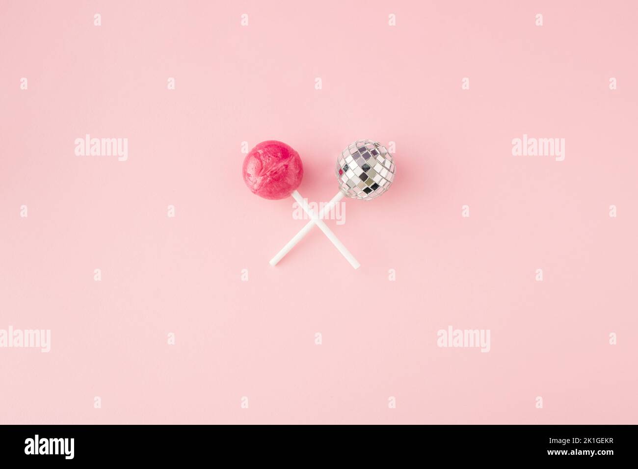 Lollipop candy and disco ball on lollipop stick on pink background ...