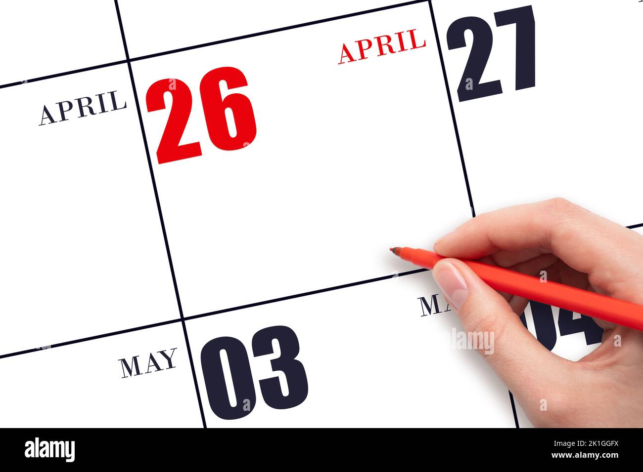 26th day of April. A hand holding a red pen and pointing on the ...