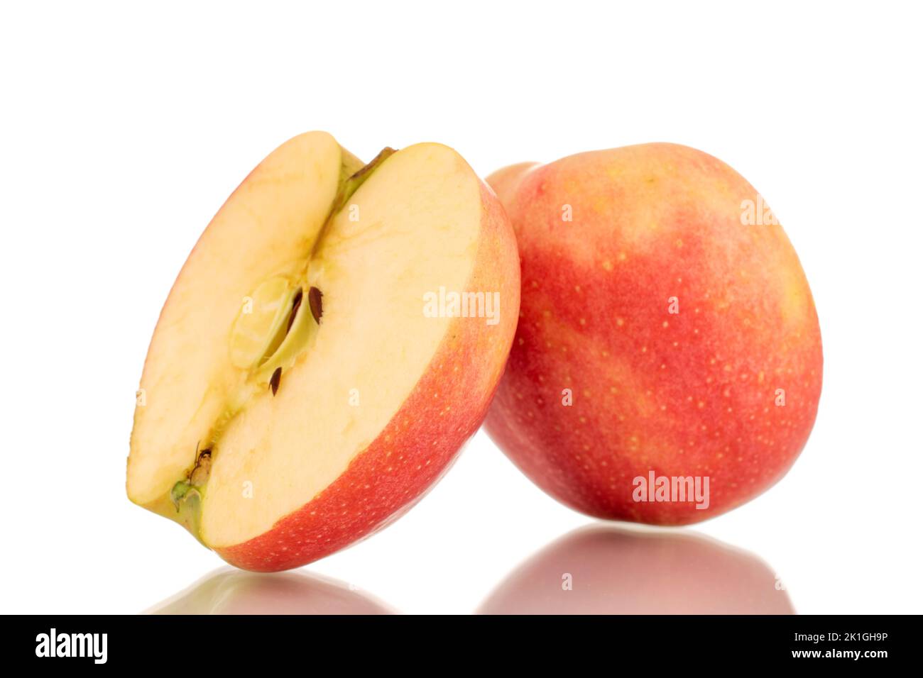 Two halves of juicy red apples, macro, isolated on white background ...