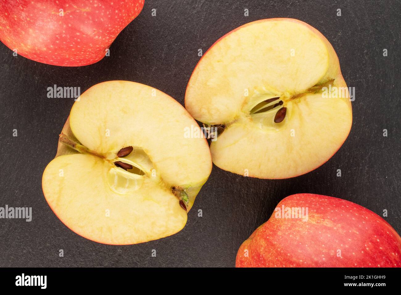 Two halves of a sweet red apple on a slate stone, macro, top view Stock ...