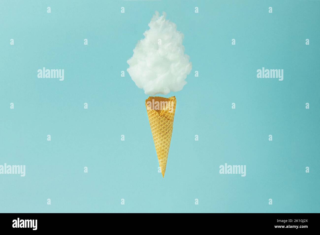 Cloud in a flying ice cream cone on the soft blue background. Minimal ...
