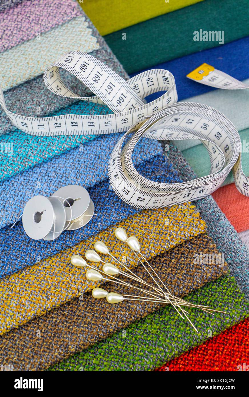 Pieces of cloth with scissors, needle and thread. Tailoring ...