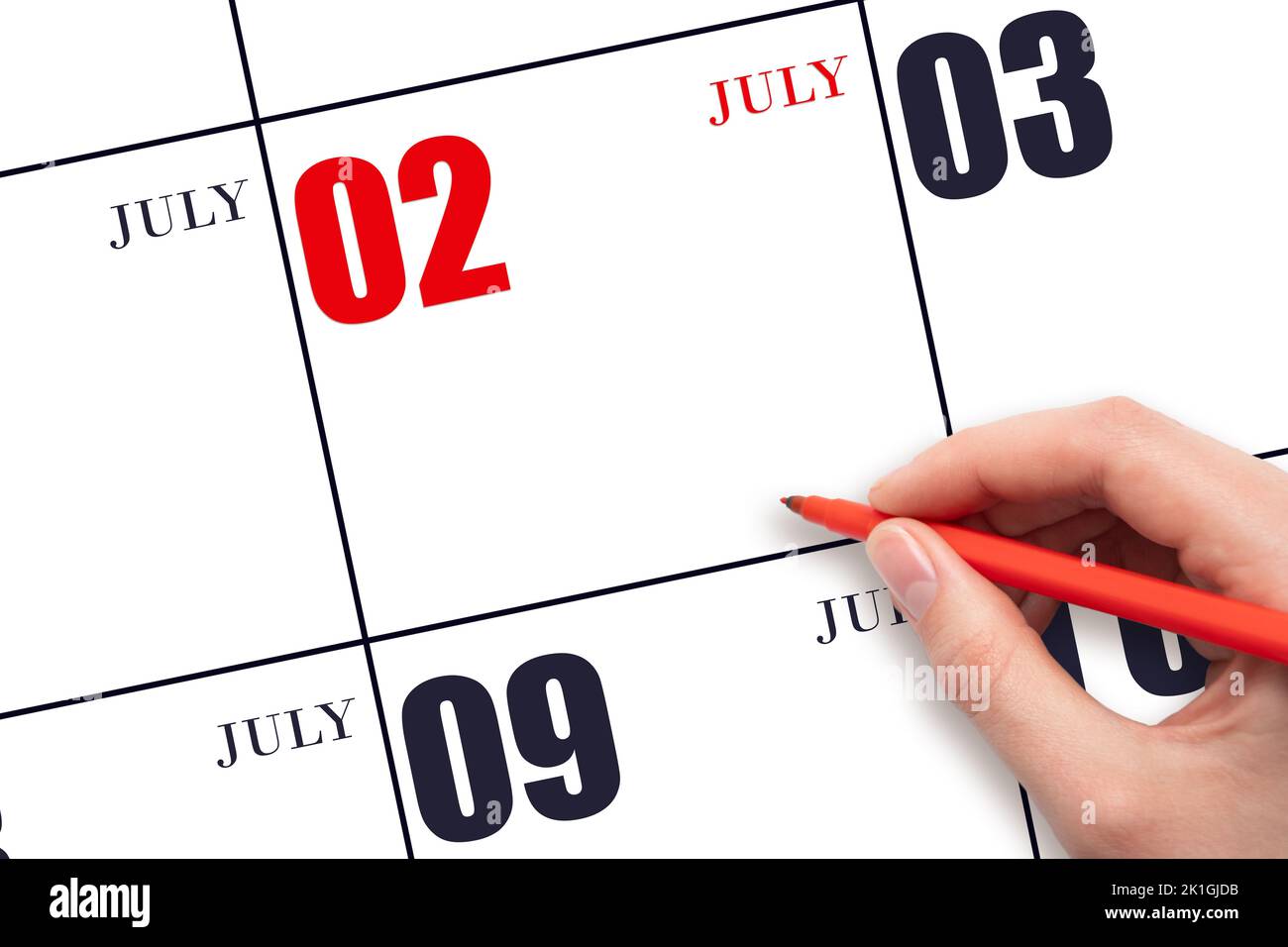 2nd day of July. A hand holding a red pen and pointing on the calendar ...