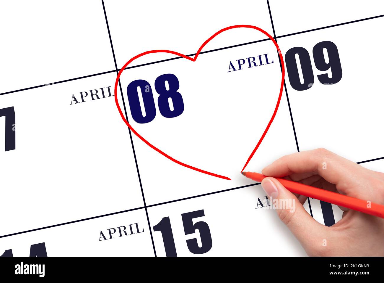 8th day of April. A woman's hand drawing a red heart shape on the ...