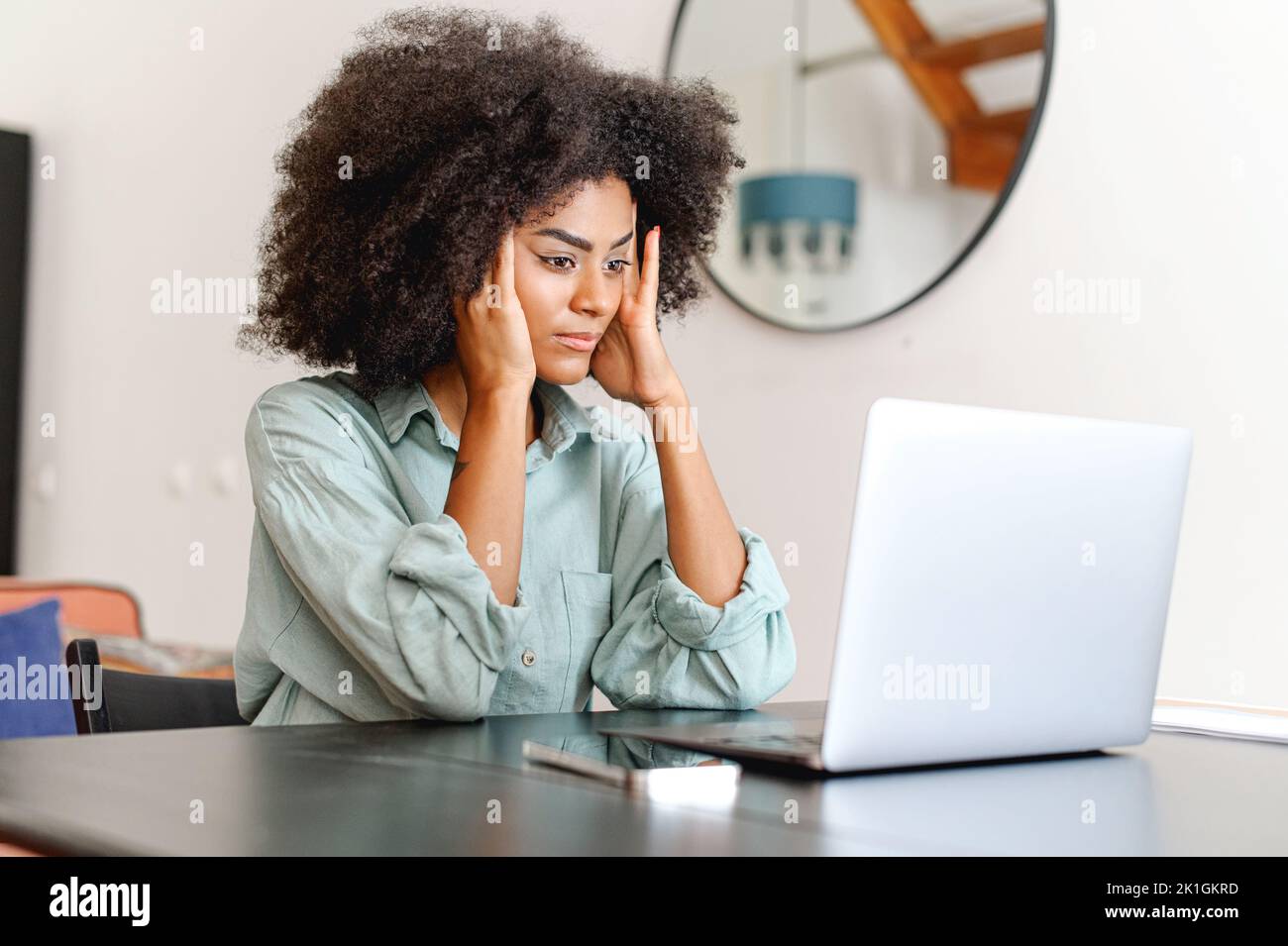 Confused black woman looking at laptop screen in despair, unemployed ...