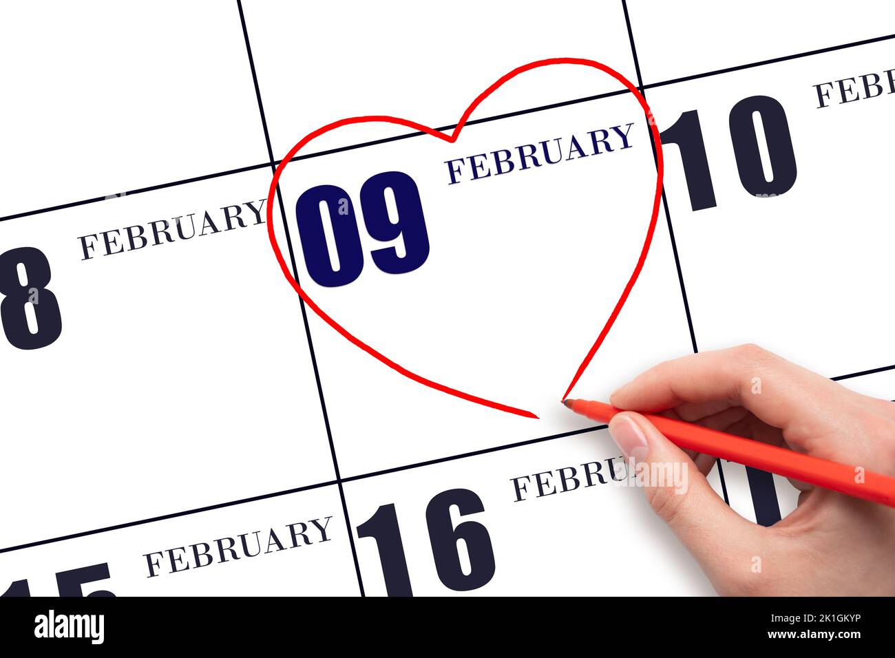 9th day of February. A woman's hand drawing a red heart shape on the ...
