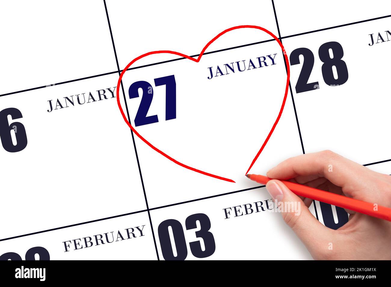 27th day of January. A woman's hand drawing a red heart shape on the ...