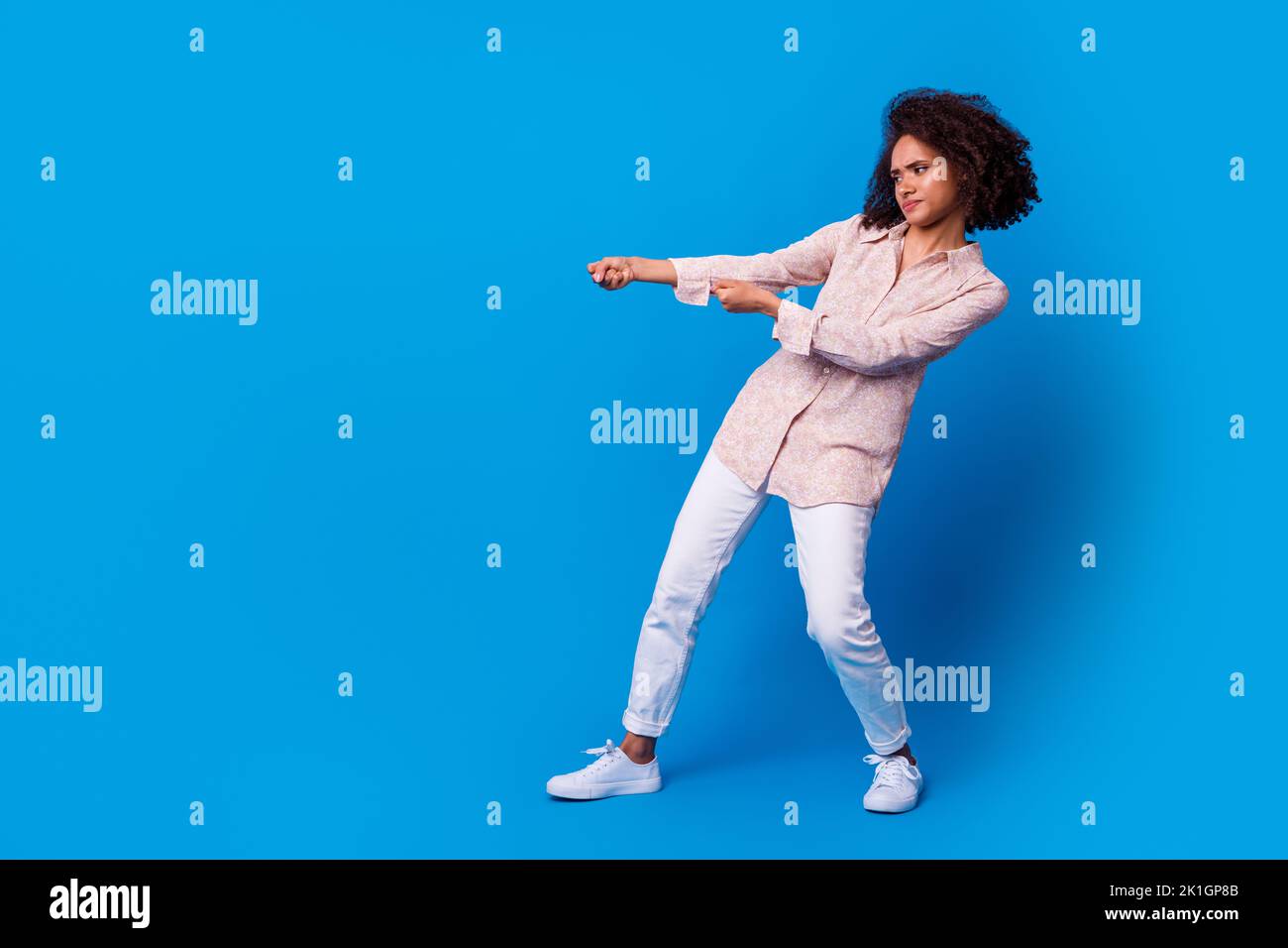 Full body portrait of hardworking determined lady arms pull empty space ...