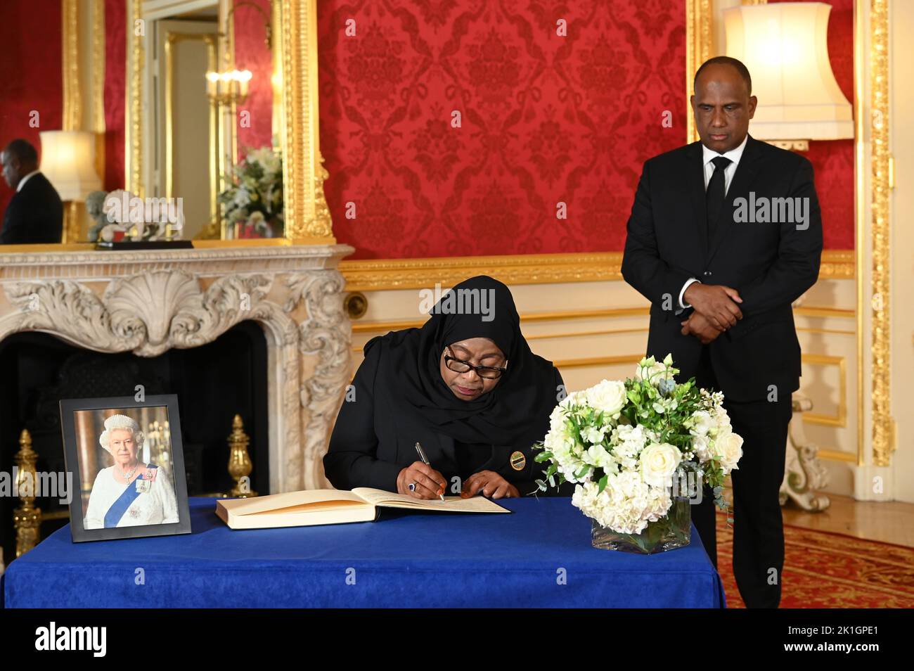 President of Tanzania Samia Suluhu Hassan signs a book of condolence at Lancaster House in ...