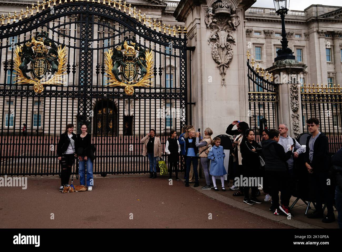 Two women (names not given) with Clive the corgi outside Buckingham ...