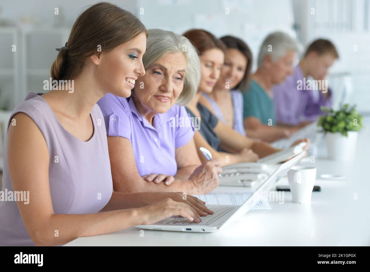 Portrait of a beautiful business girl and business team Stock Photo - Alamy