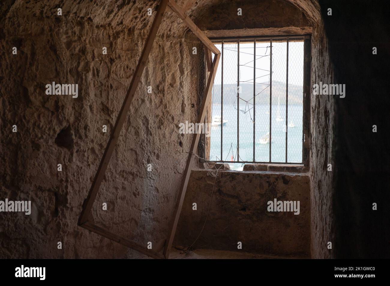 Window in medieval castle tower in Trogir, Croatia. Broken grid, fixed ...