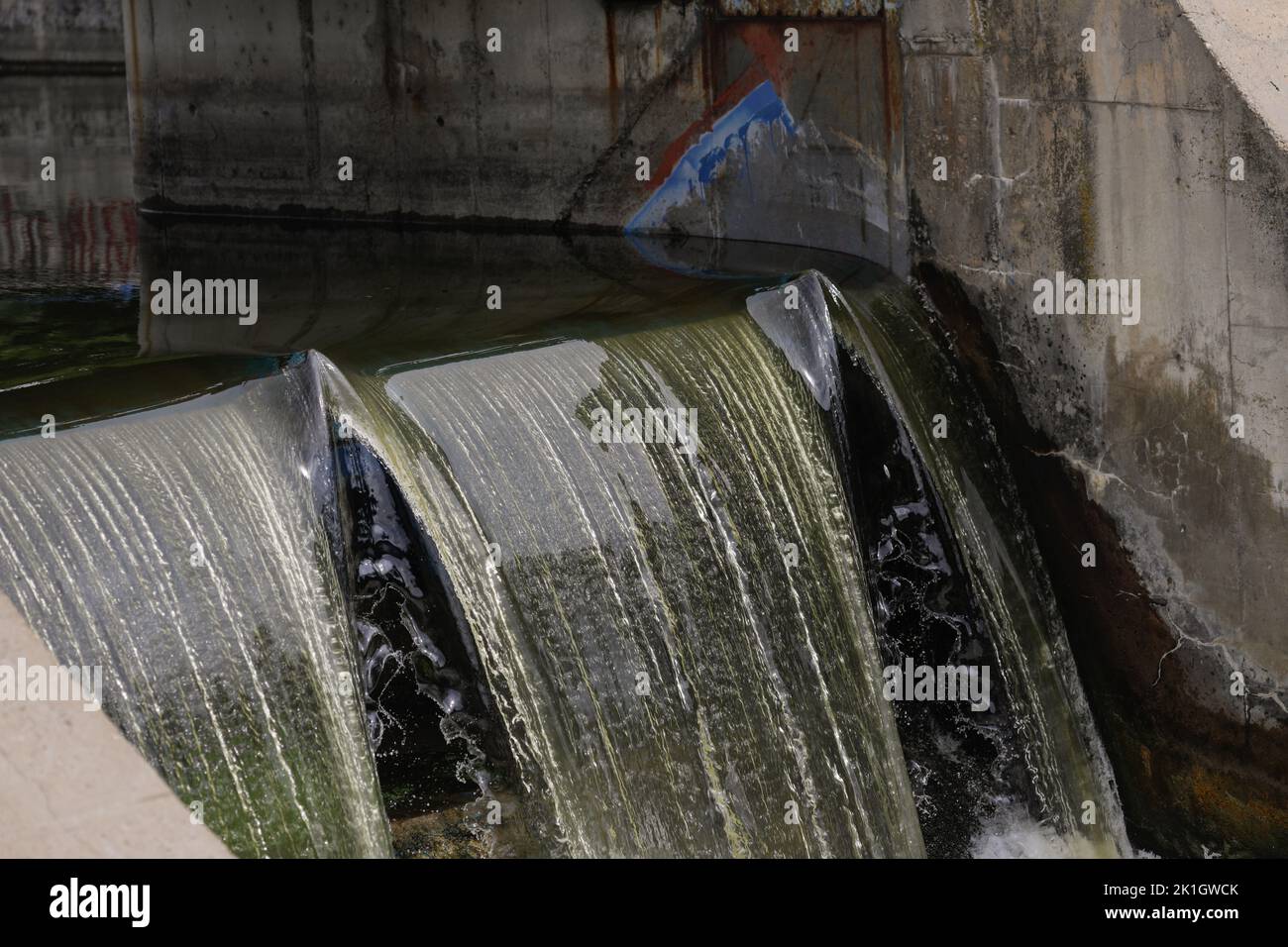Water flowing through a sluice on a river Stock Photo - Alamy