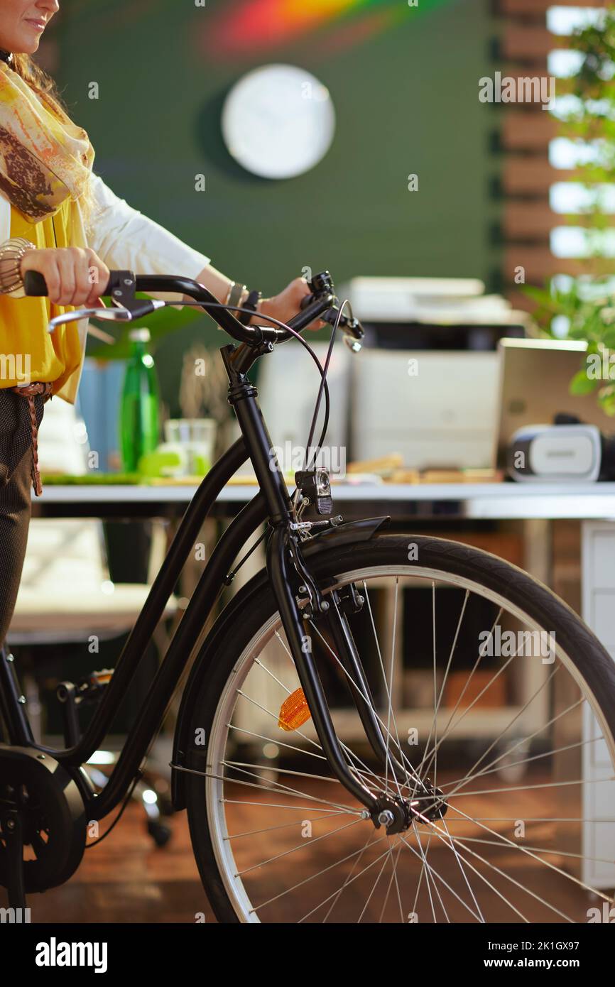 Closeup on business woman with bicycle in eco office Stock Photo - Alamy