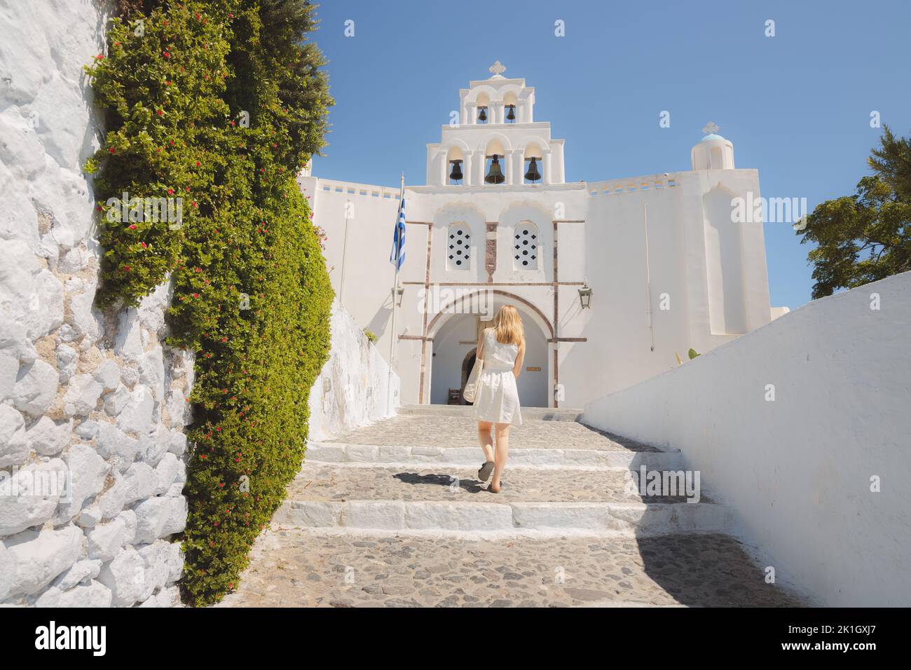 A young blonde female tourist explores the traditional old town ...
