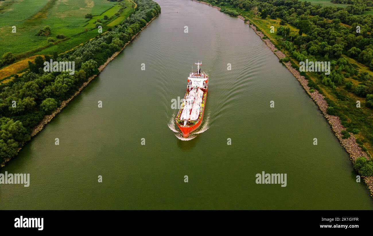 Aerial photography of a cargo transport ship seen on Danube at sunrise ...