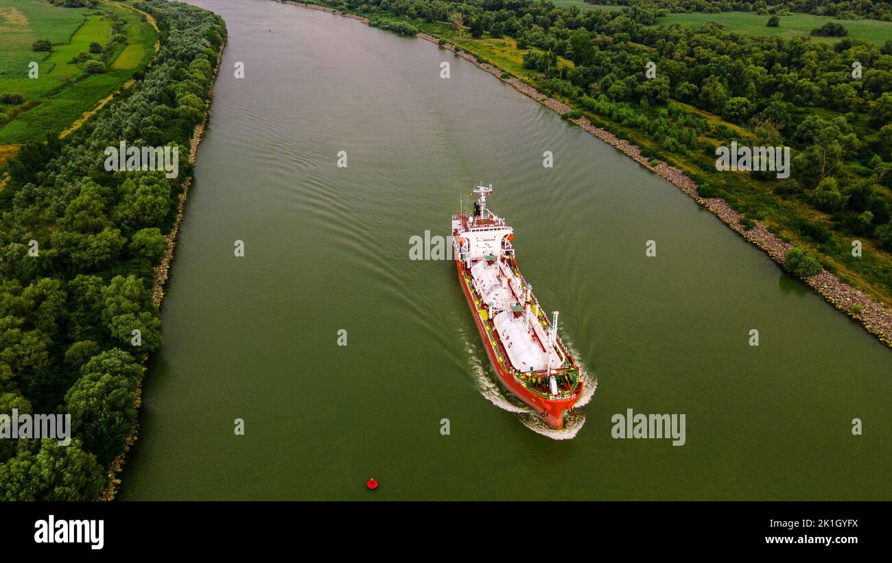 Aerial photography of a cargo transport ship seen on Danube at sunrise ...