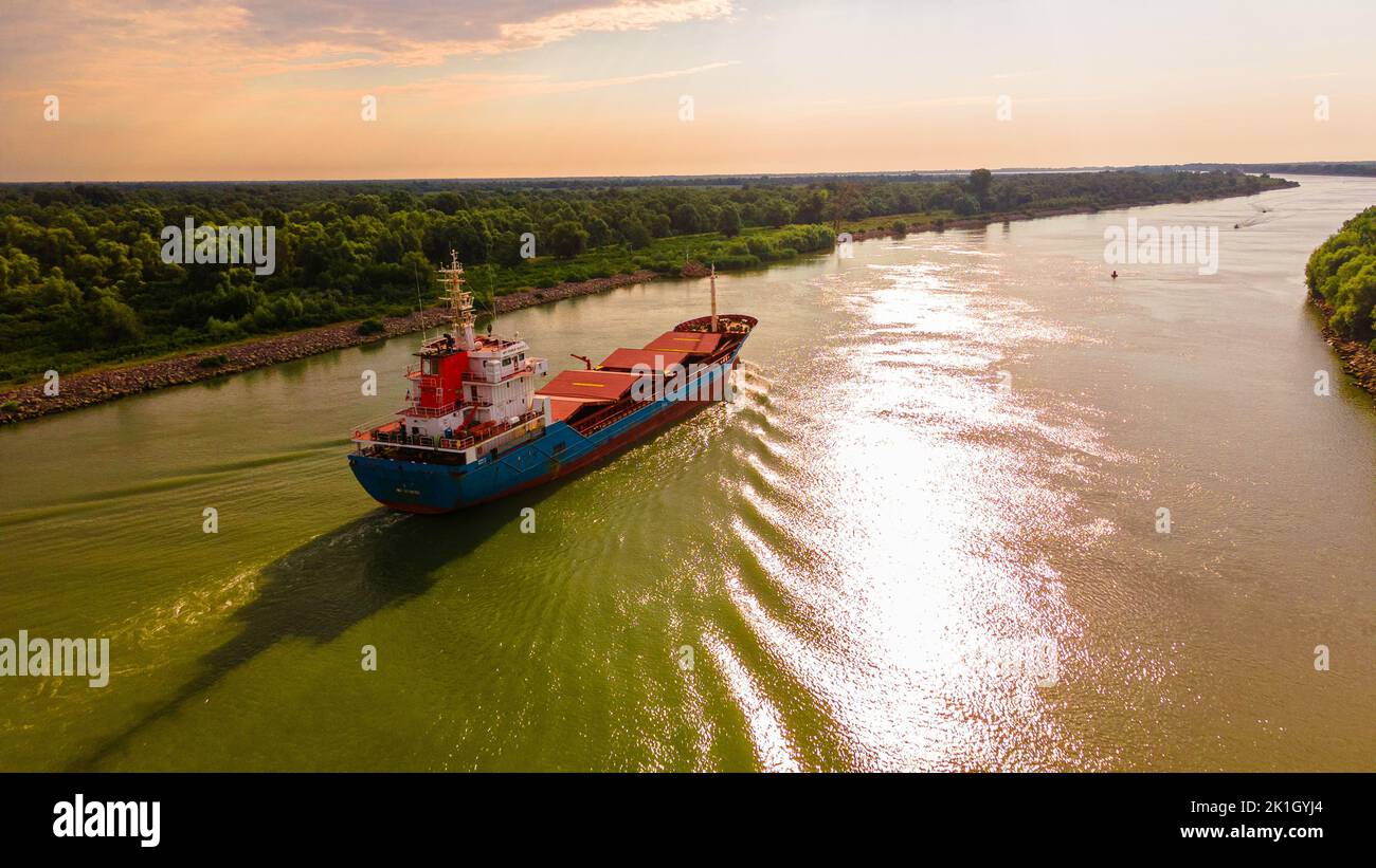 Aerial photography of a cargo transport ship seen on Danube at sunrise ...