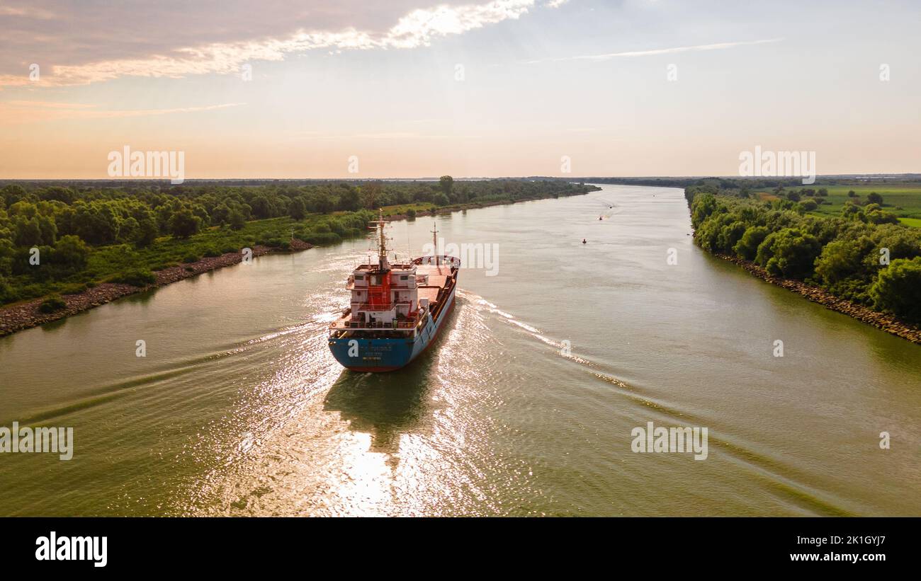 Aerial photography of a cargo transport ship seen on Danube at sunrise ...