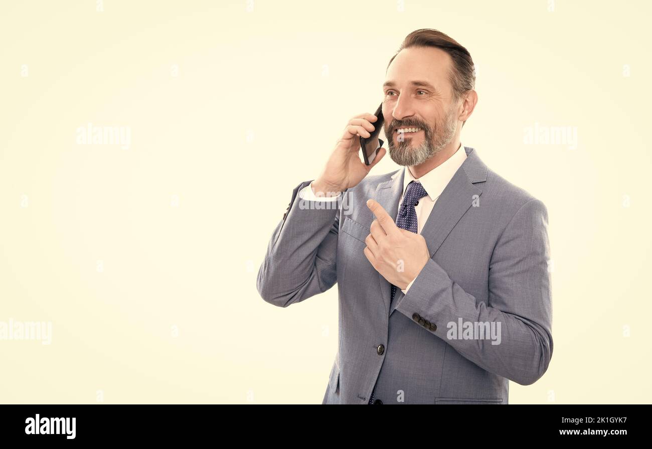 happy mature manager in suit talking on mobile phone isolated on white ...