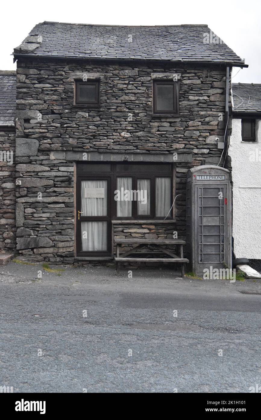 A roadside stone cottage and disused telephone box at Kirkstone Pass ...