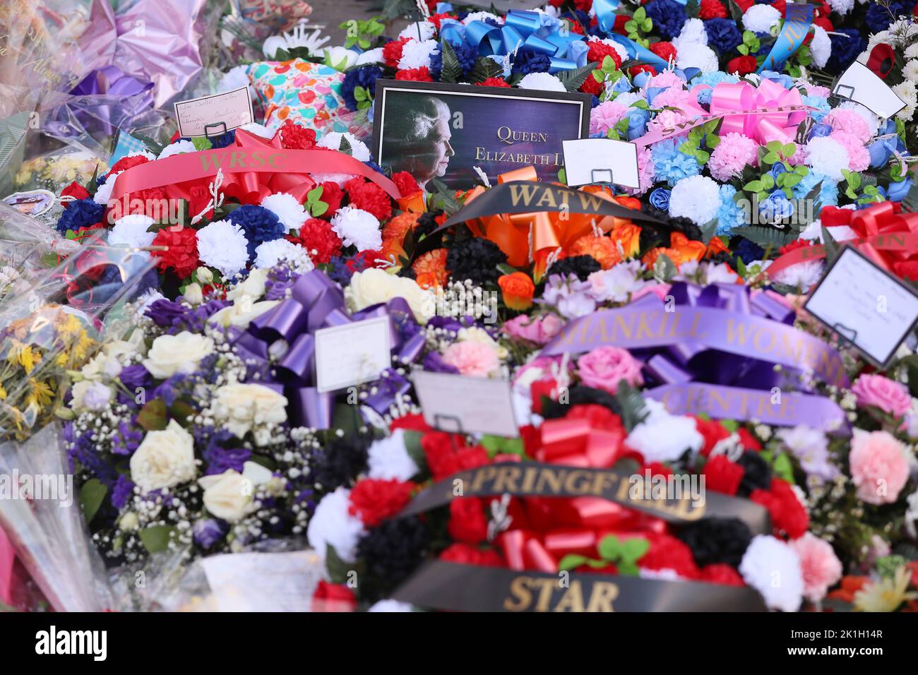 People lays flowers at a mural depicting Queen Elizabeth II on the ...