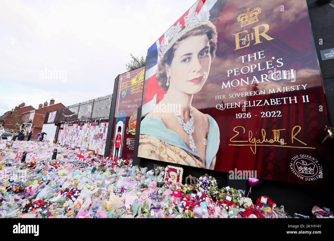 People lays flowers at a mural depicting Queen Elizabeth II on the ...